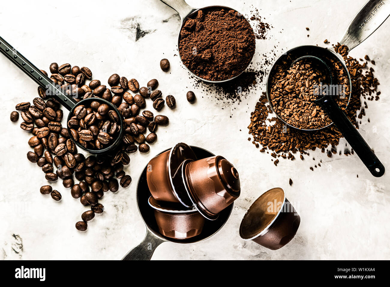 Coffee concept - beans, ground, instant, capsules, marble background ...