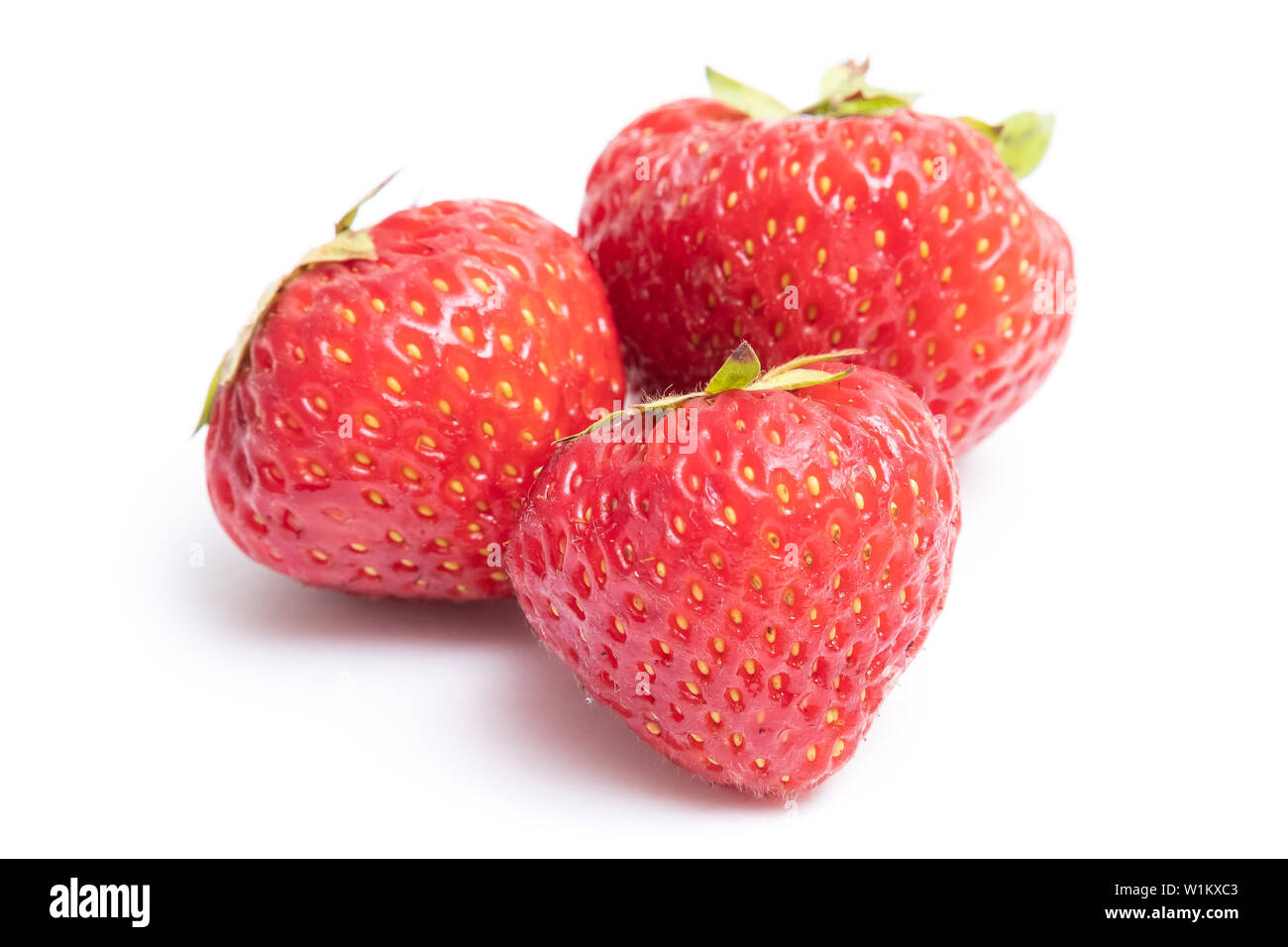Description: Three fresh strawberries isolated on white background ...