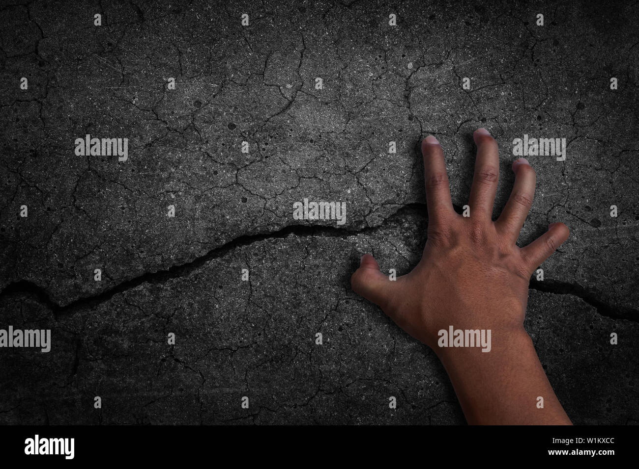 Hand of Darkness cracked black background Stock Photo - Alamy