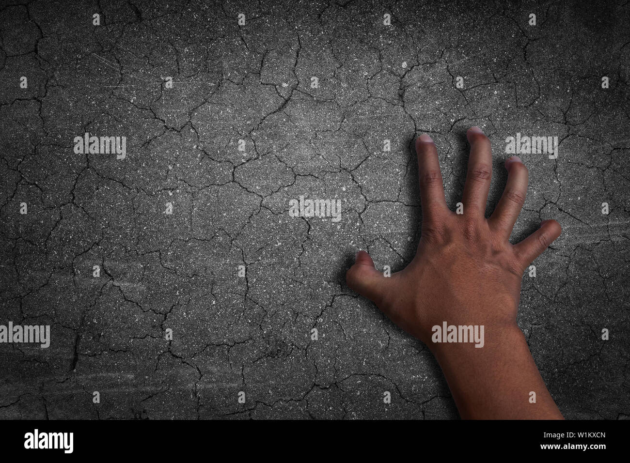 Hand of Darkness cracked black background Stock Photo - Alamy