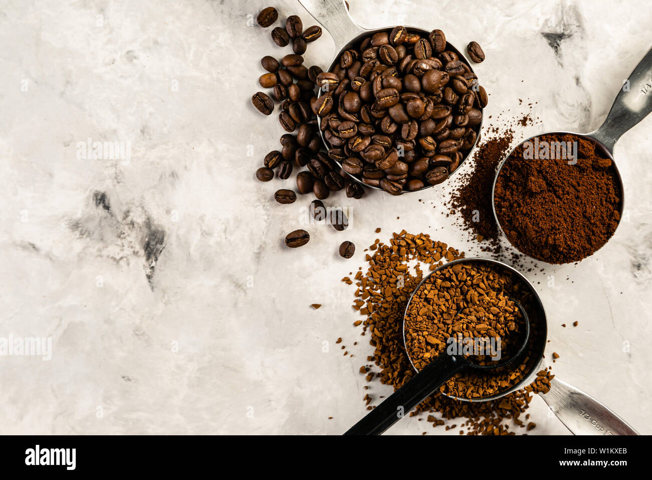 Coffee concept - beans, ground, instant, capsules, marble background ...
