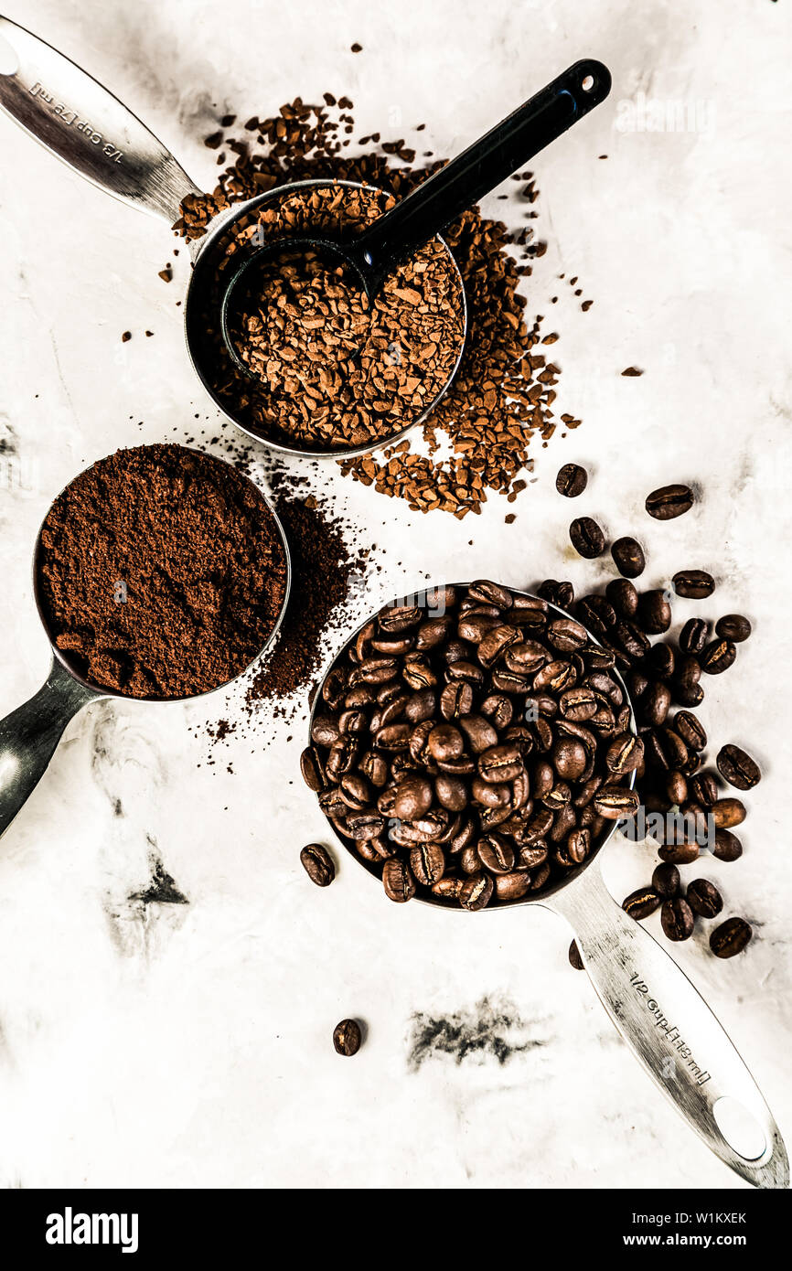Coffee concept - beans, ground, instant, capsules, marble background ...