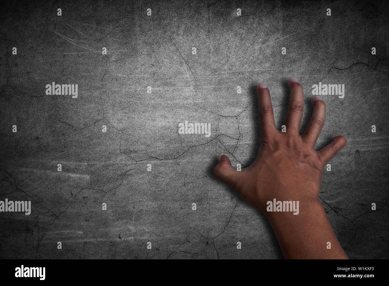 Hand of Darkness cracked black background Stock Photo - Alamy