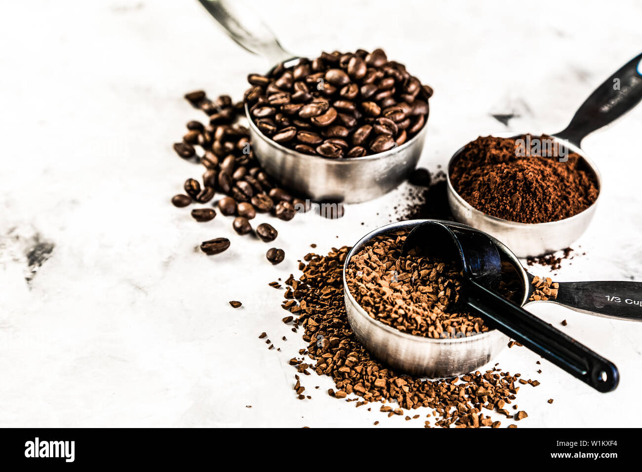 Coffee concept - beans, ground, instant, capsules, marble background ...