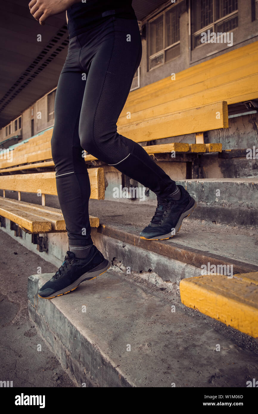 Caucasian man trains in running on the stairs. Track and field runner ...