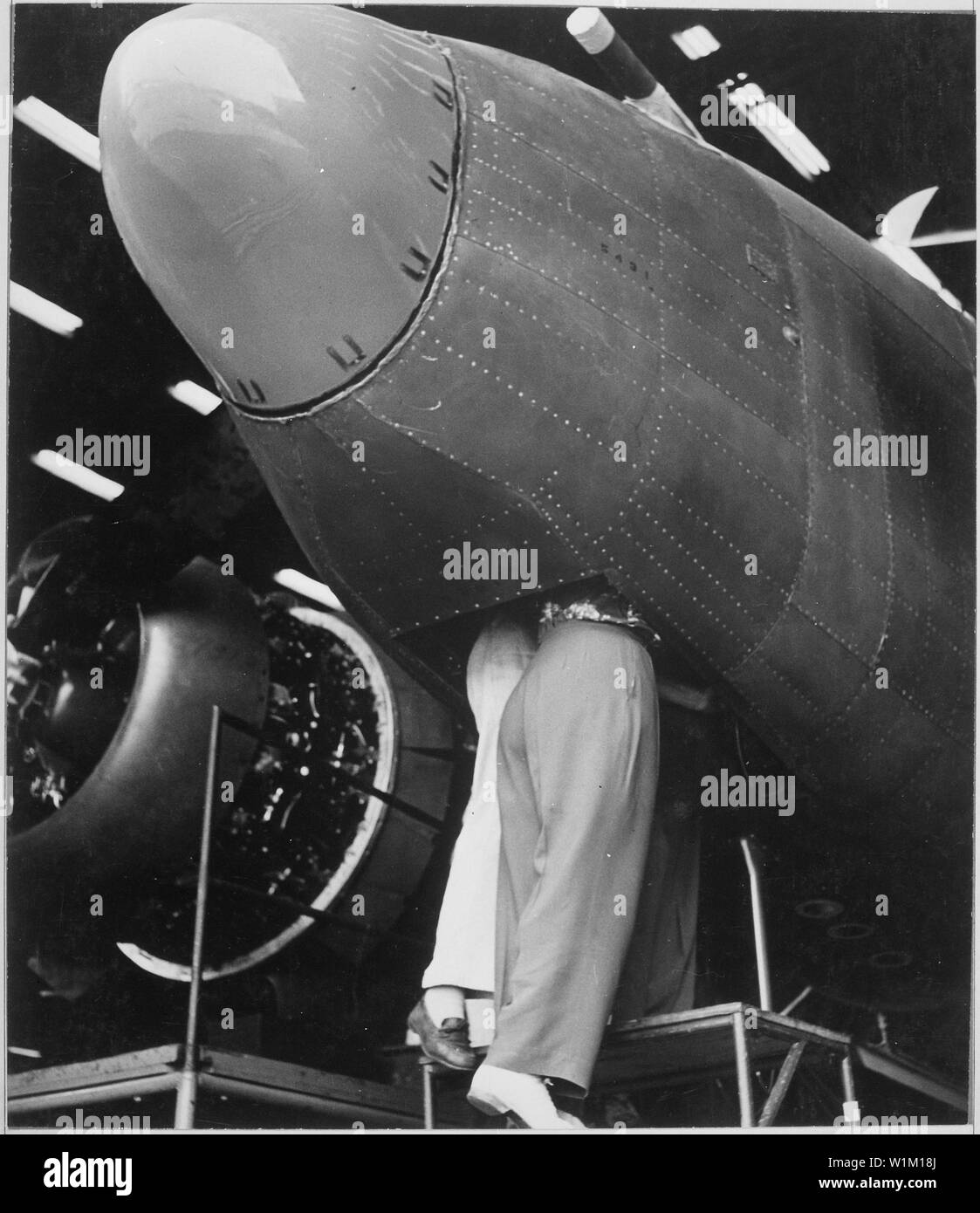 Workmen at the Vega aircraft plant, Burbank, California Two women ...