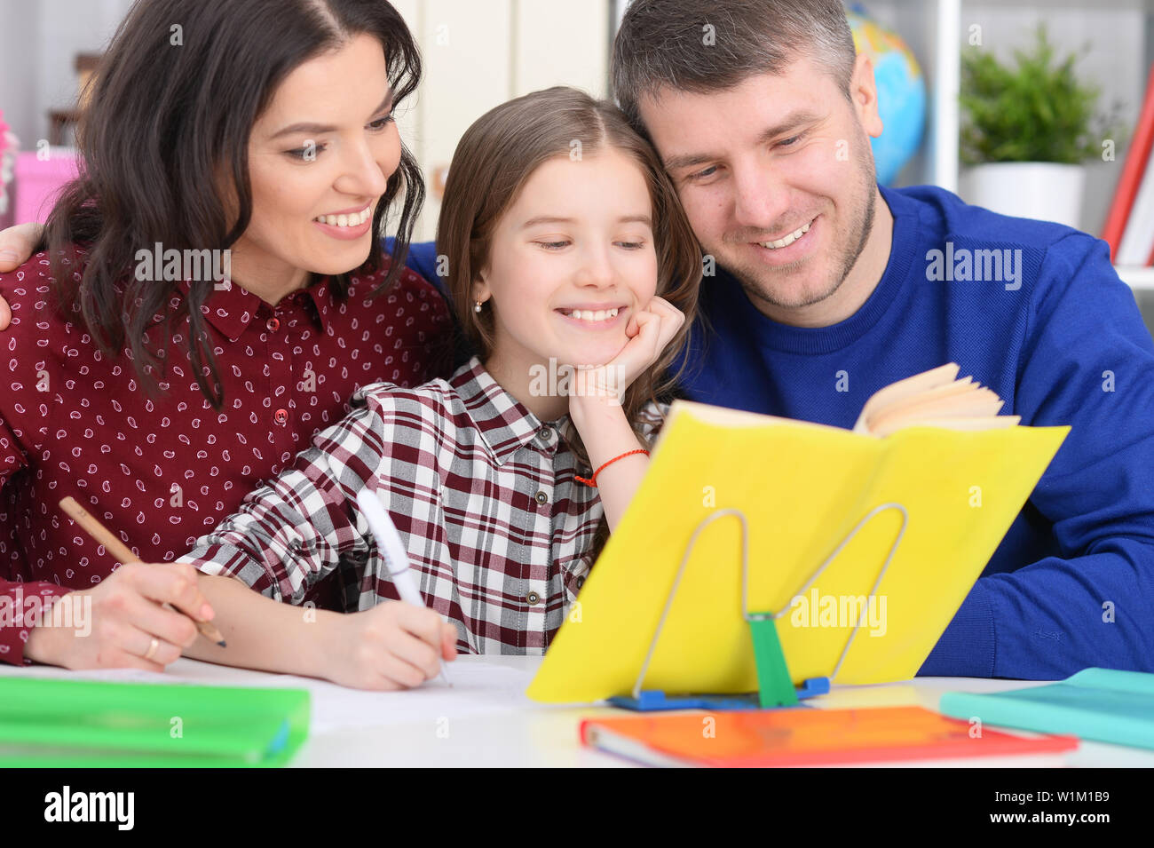 Children doing homework with parents hi-res stock photography and images - Alamy
