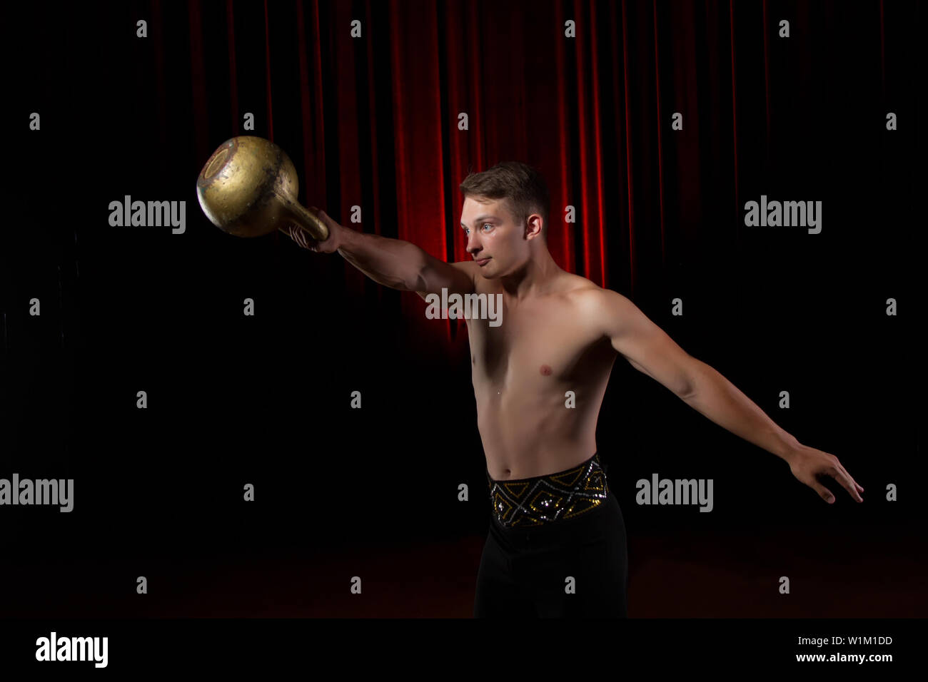 Power gymnast circus with weight.Handsome guy with a muscular body ...