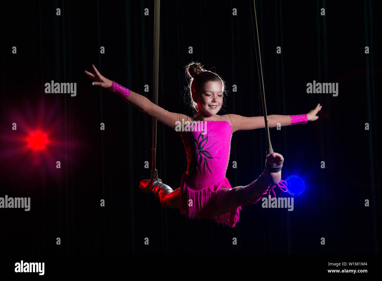 Circus artist acrobat performance. The girl performs acrobatic elements ...