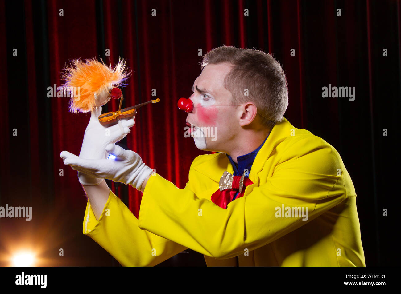Circus clown performs number. A man in a clown outfit with a toy Stock ...