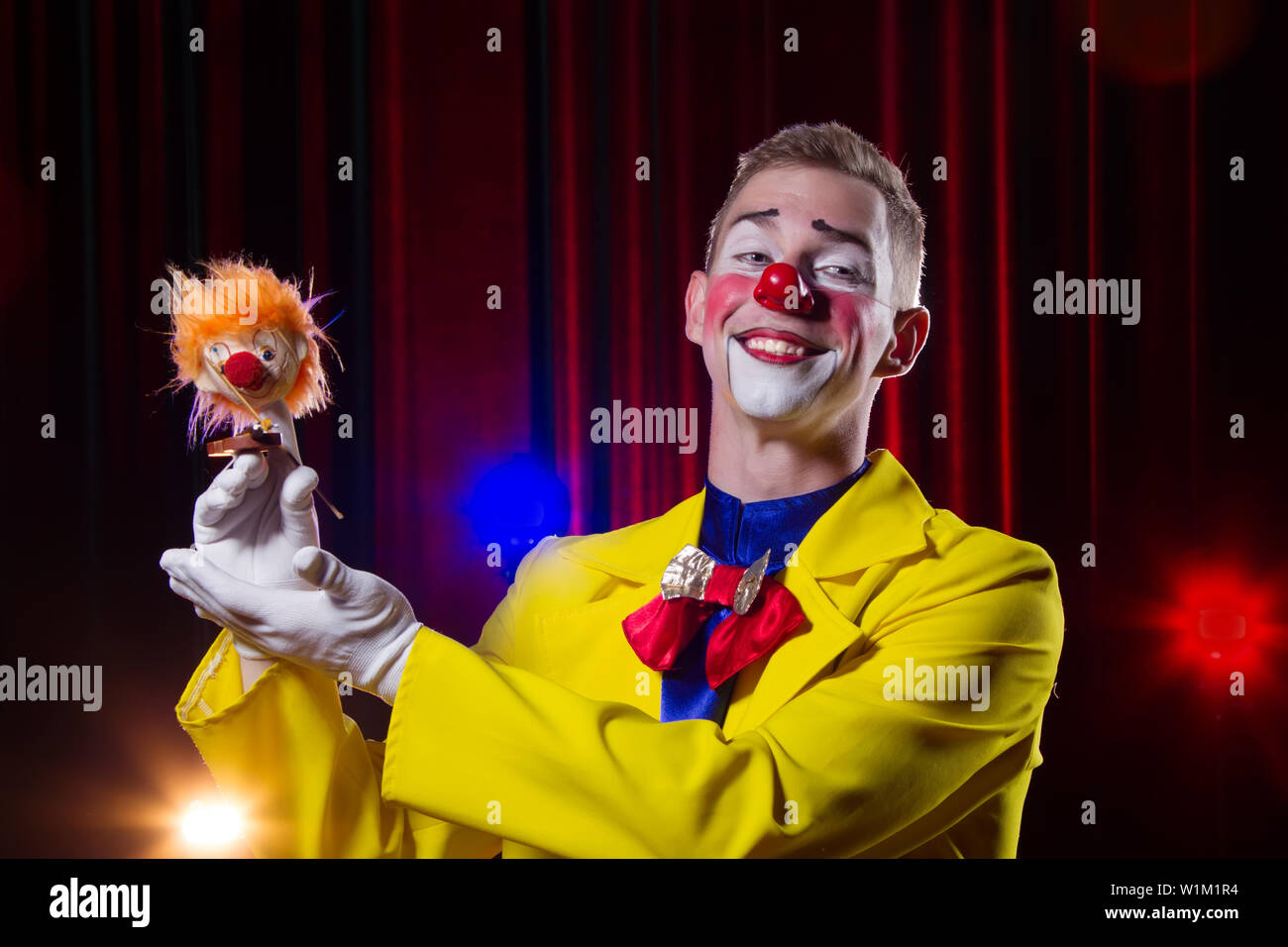 Circus clown performs number. A man in a clown outfit with a toy Stock ...