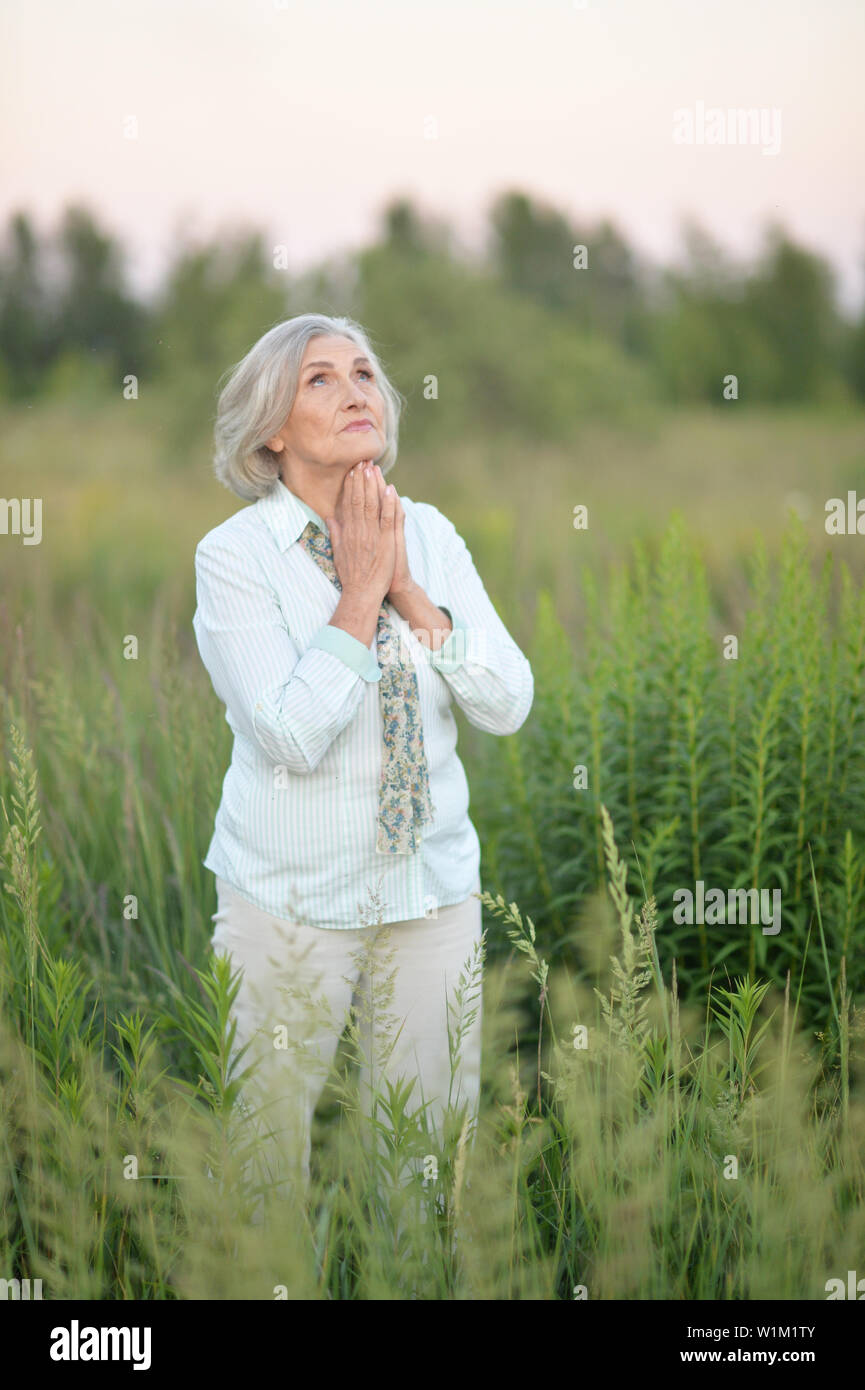 Portrait of happy senior beautiful woman praying Stock Photo - Alamy