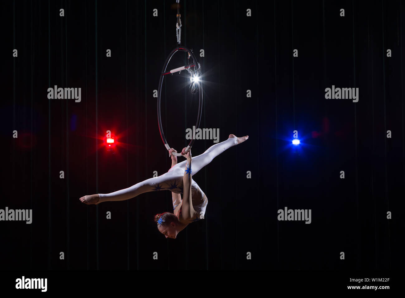 Performs a circus girl actress. Circus aerial gymnast on the hoop ...
