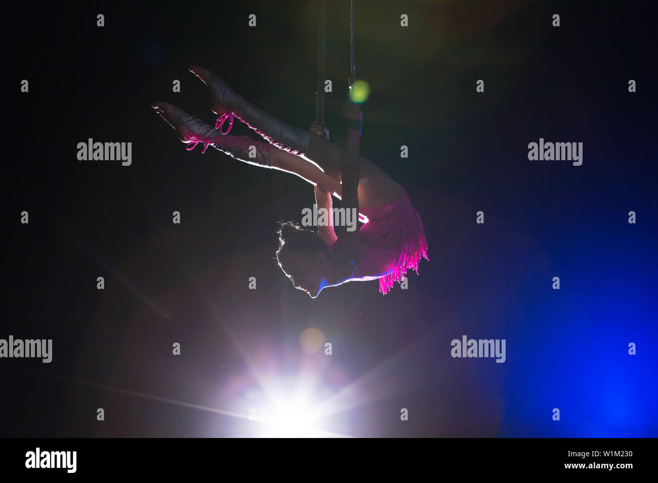 Circus artist acrobat performance. The girl performs acrobatic elements ...