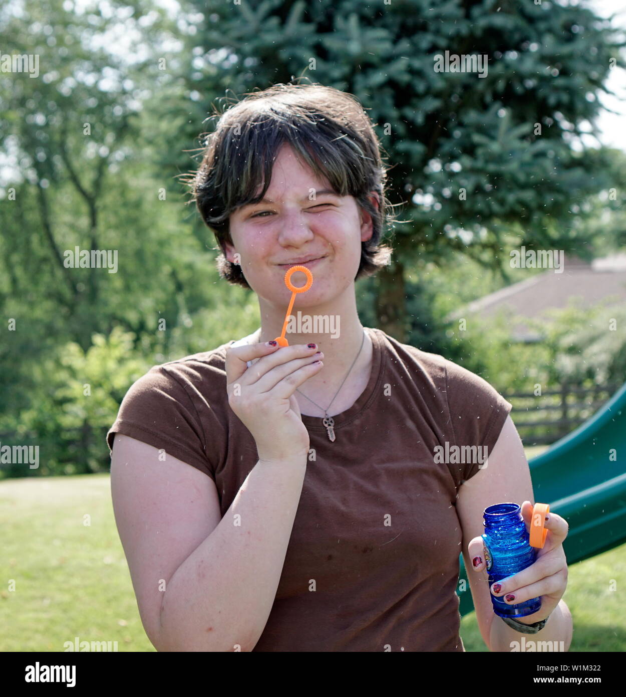 Teen girl surprised by bubble popping Stock Photo - Alamy