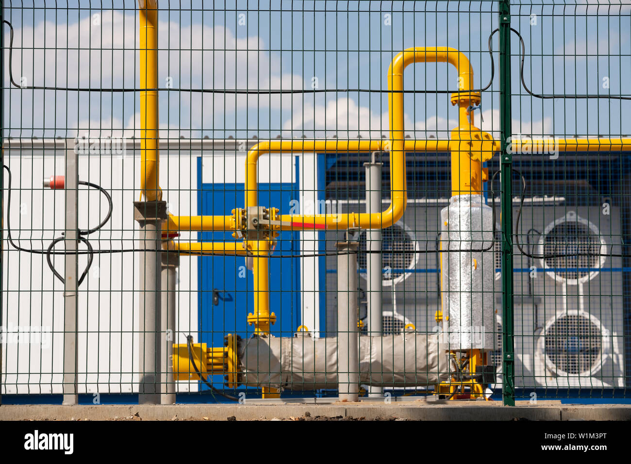 description: Gas pipeline and valve behind metallic fence Stock Photo ...