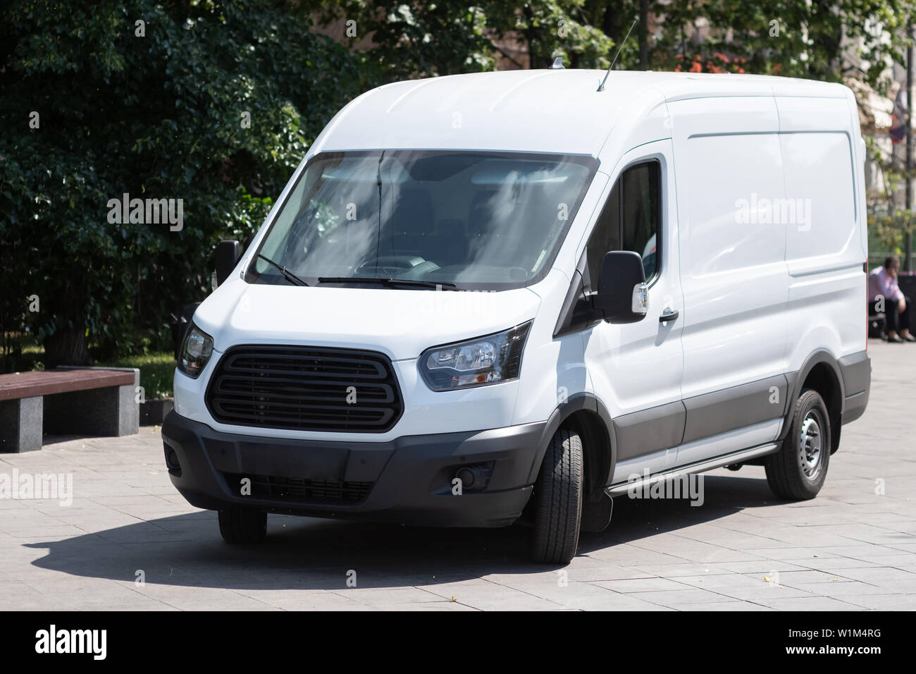 description: white minibus is parked in city street Stock Photo - Alamy