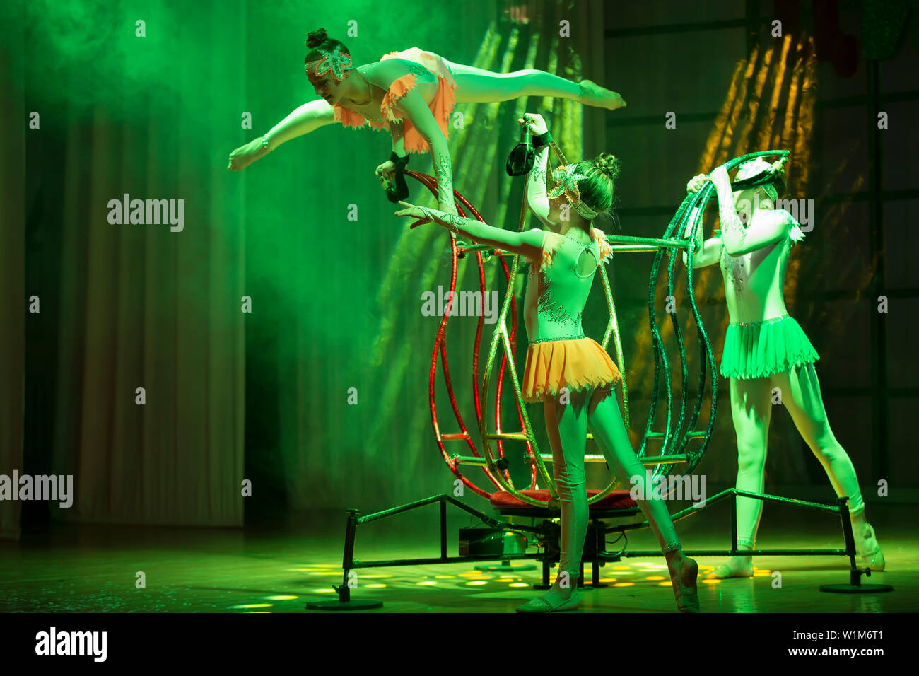 .Performance of circus acrobats on stage.Speech circus acrobats on stage. Three girls g Stock ...