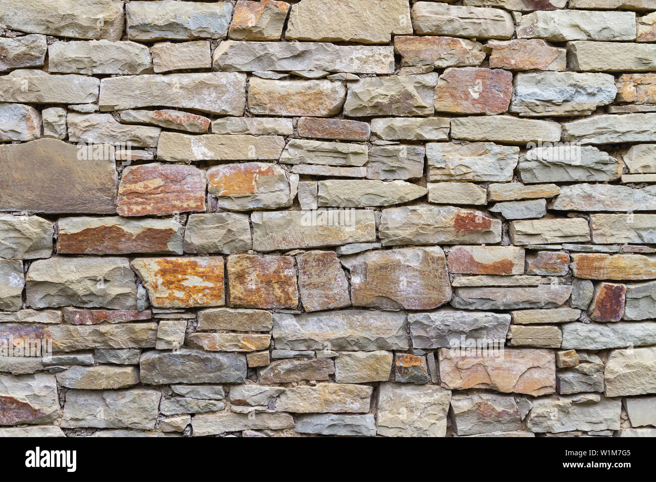 A fragment of stonework from gray and reddish stone in natural light ...