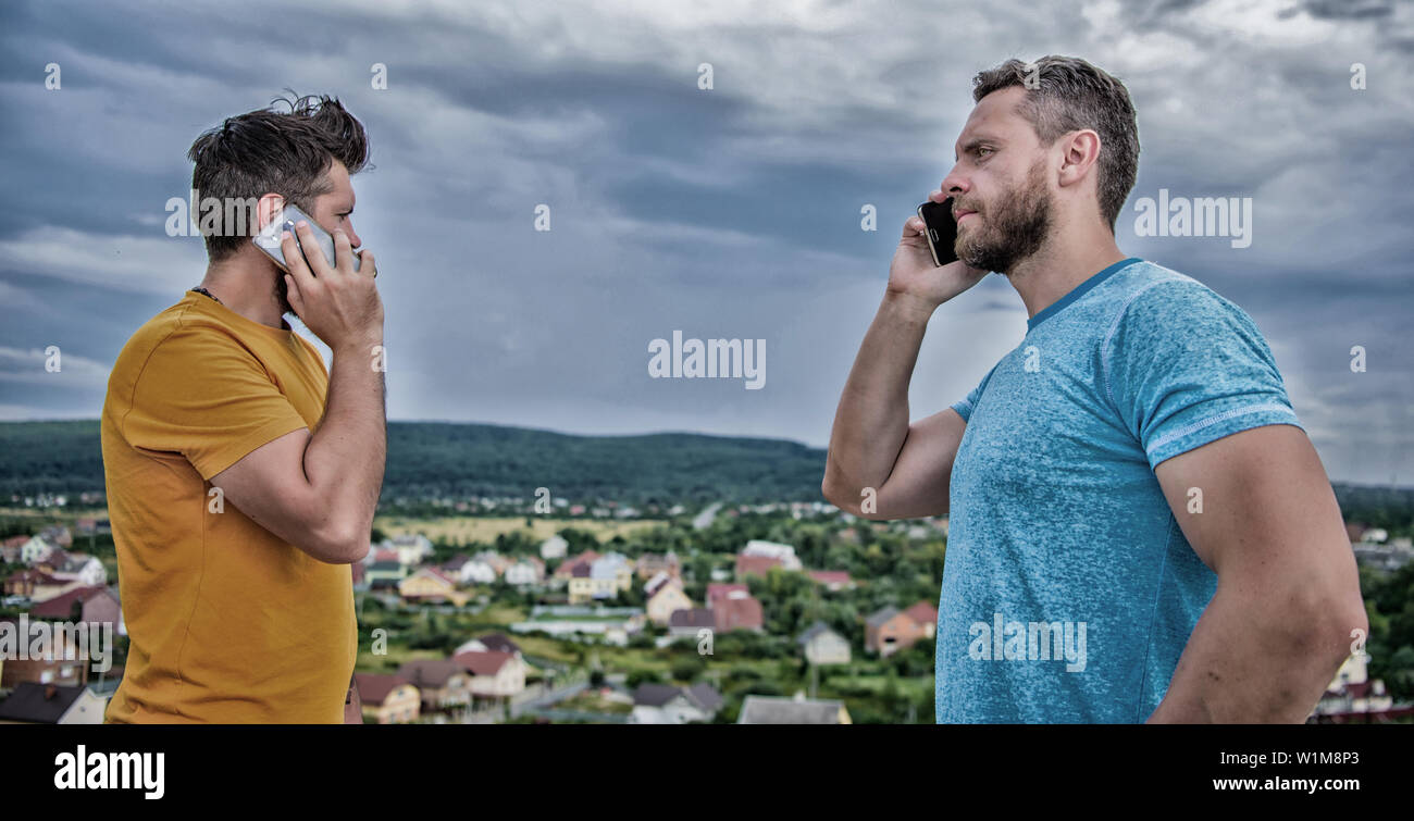 Talking with friends. Smartphone together. Friends talking usin Stock ...