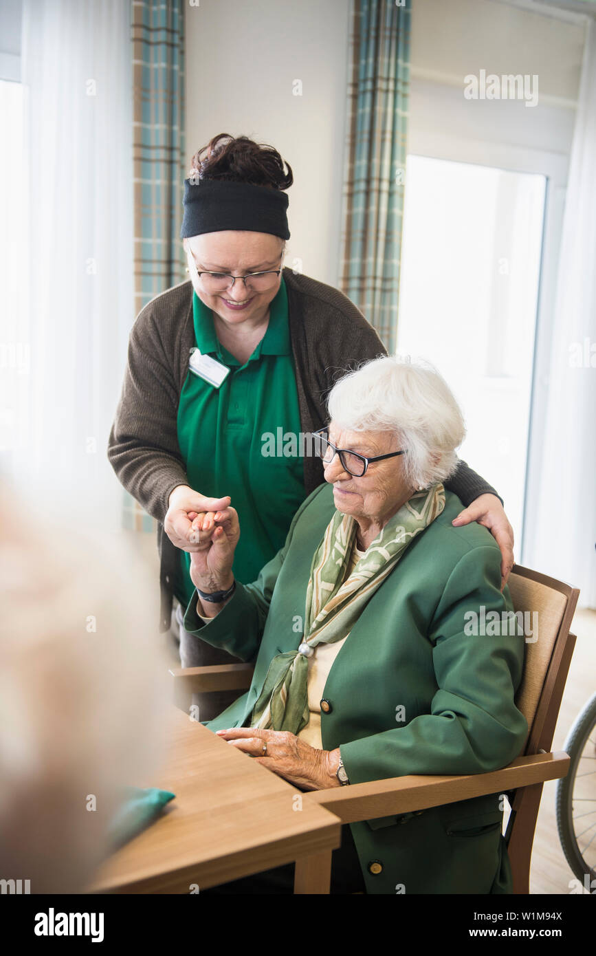 Nursing staff caring about Senior woman in rest home Stock Photo - Alamy