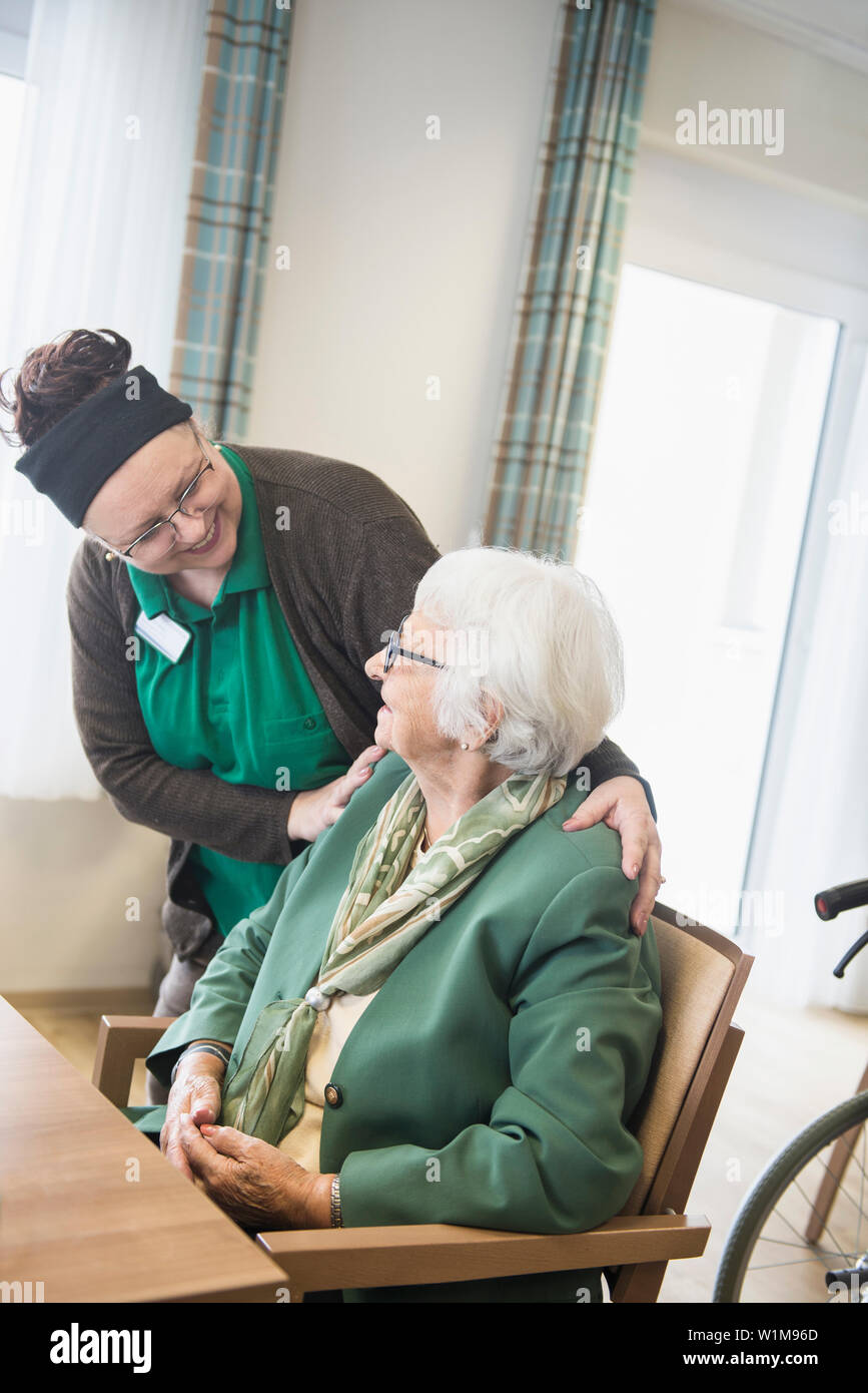 Nursing staff caring about senior woman in rest home Stock Photo - Alamy