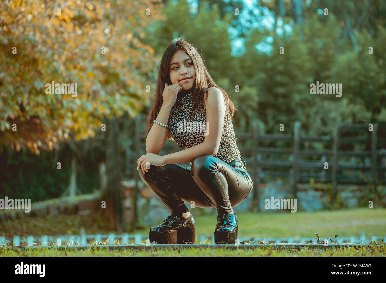 Young girl modeling in park Stock Photo - Alamy