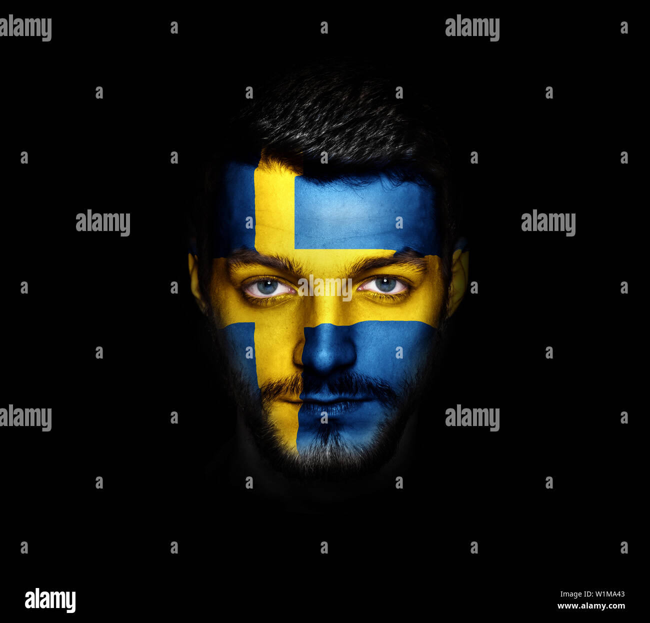 Flag of Sweden painted on a face of a man Stock Photo - Alamy
