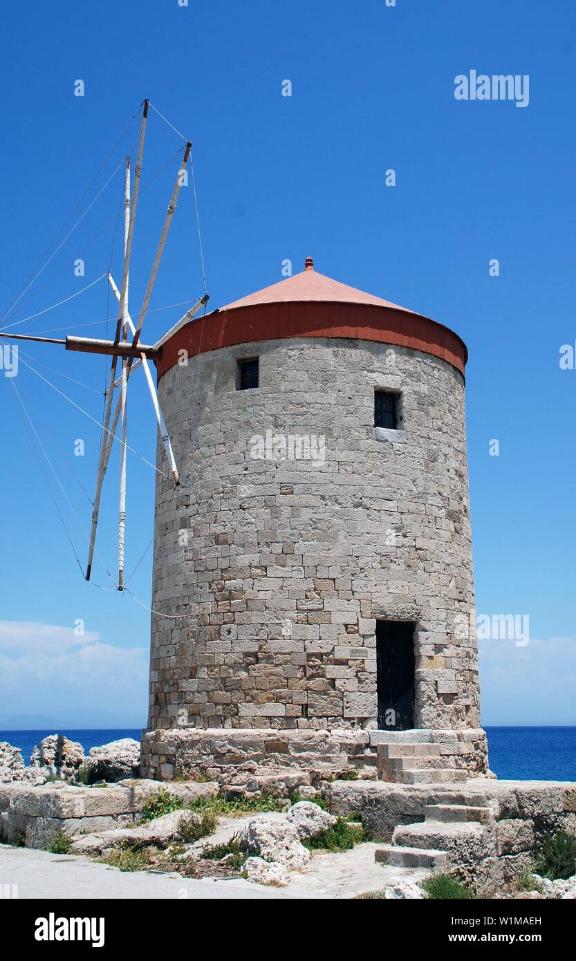 A medieval stone windmill at Mandraki harbour in Rhodes Old Town on the ...