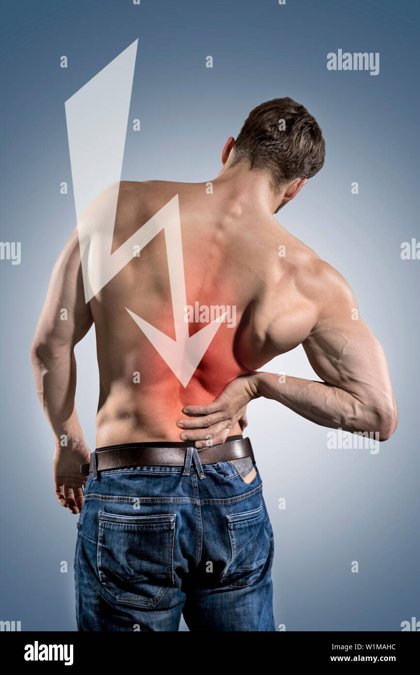 Rear view of shirtless muscular man suffering with lower back pain ...