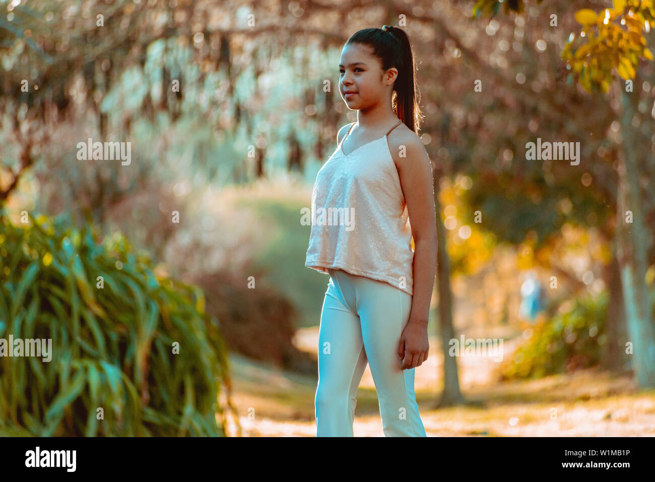 girl modeling with elegant cloth in park Stock Photo - Alamy