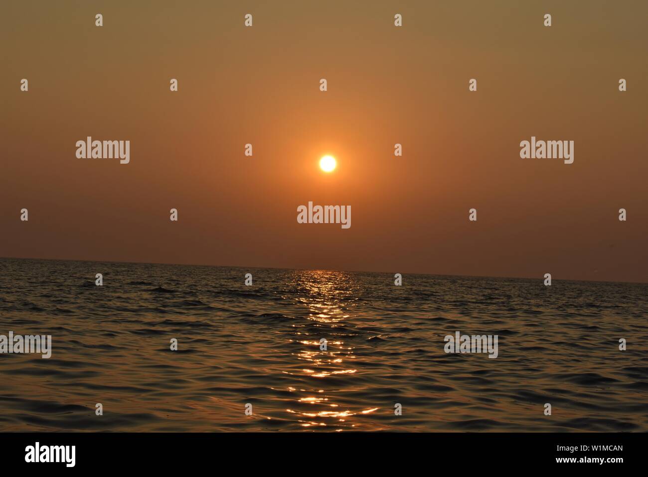 Beautiful View of the sunset over the indian Ocean on the shores of goa ...