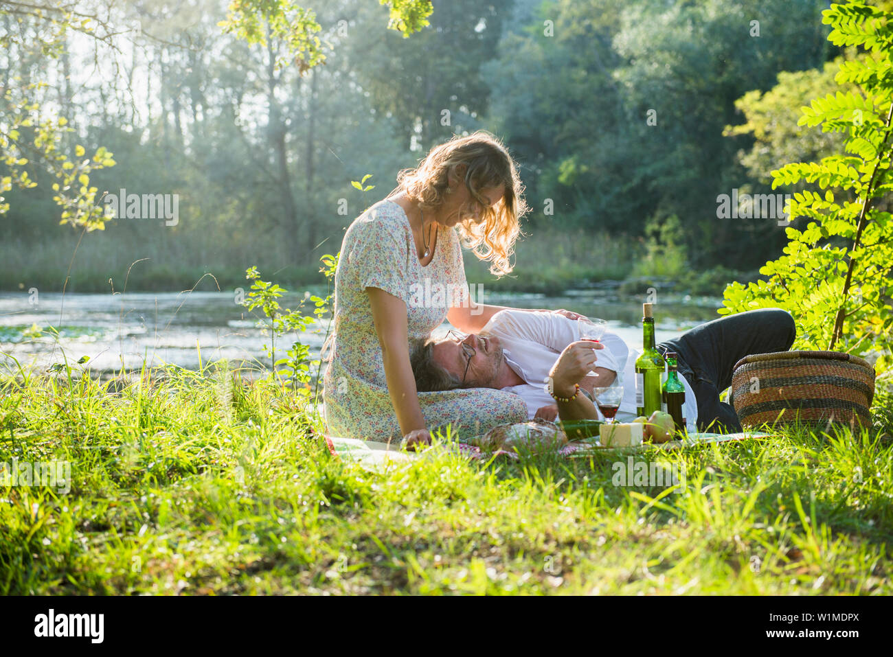Romantic couple enjoying picnic by lake, Germany Stock Photo - Alamy