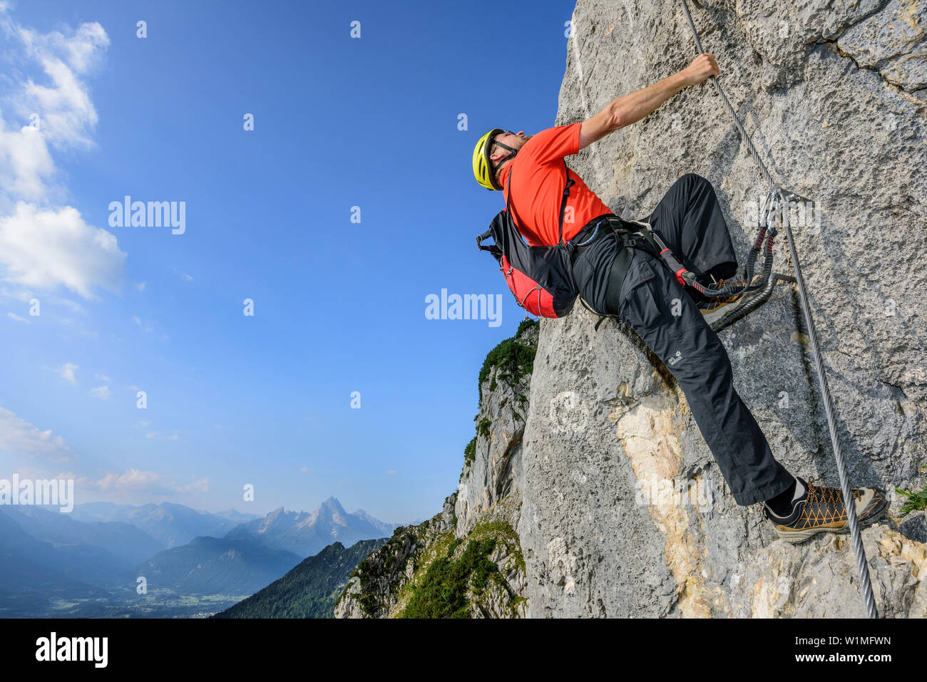 Man ascending fixed rope route, Watzmann in background ...