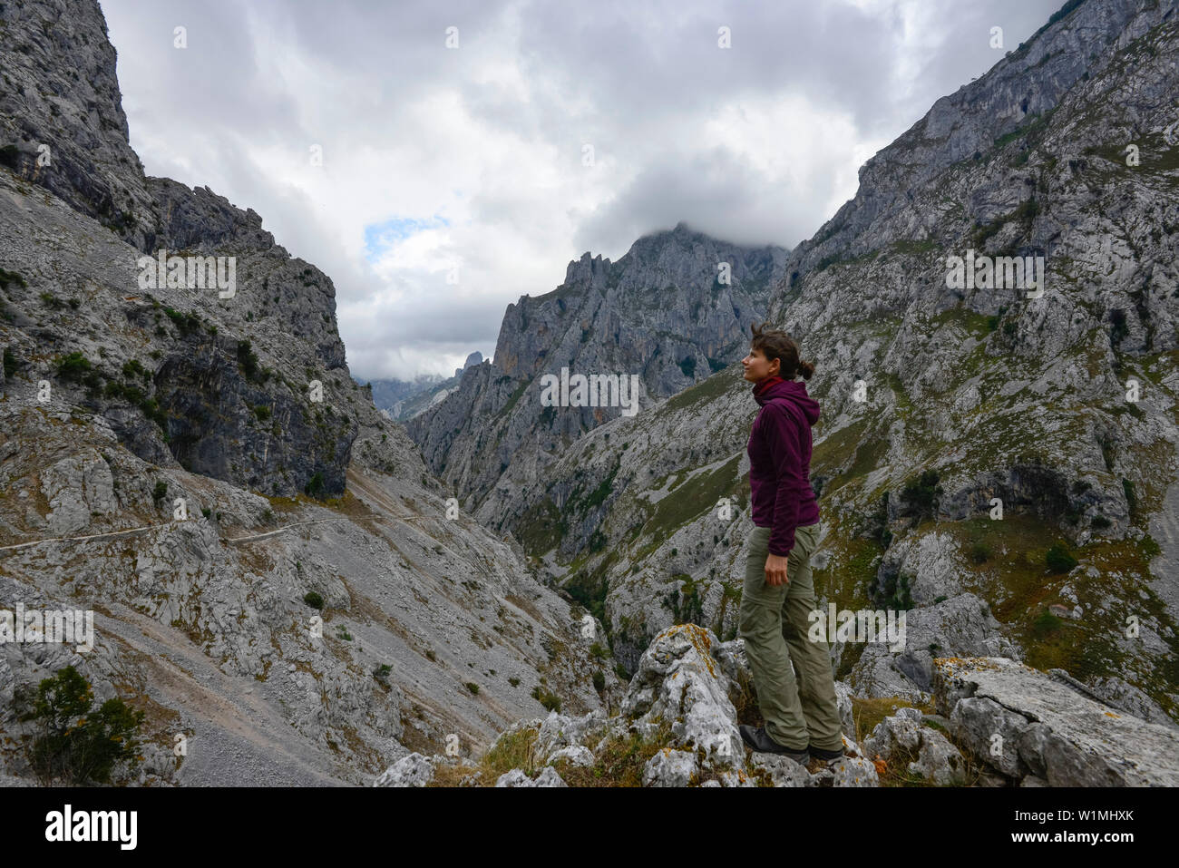young woman at hiking trail Ruta del Cares is connecting Bulnes and ...
