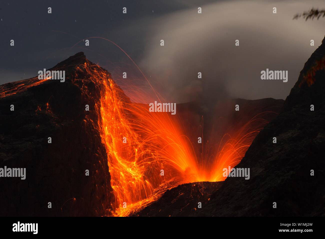 Close up of a huge eruption of Batu Tara volcano with lava bombs during ...