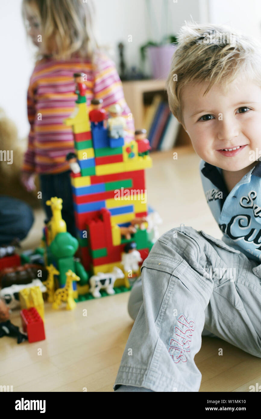 Children playing with plastic bricks Stock Photo - Alamy