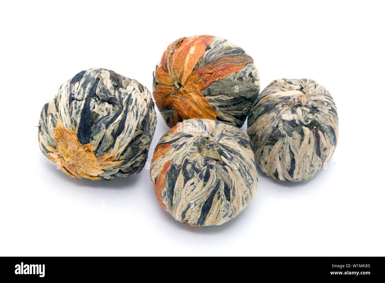 green tea in balls on a white background with shadow Stock Photo - Alamy