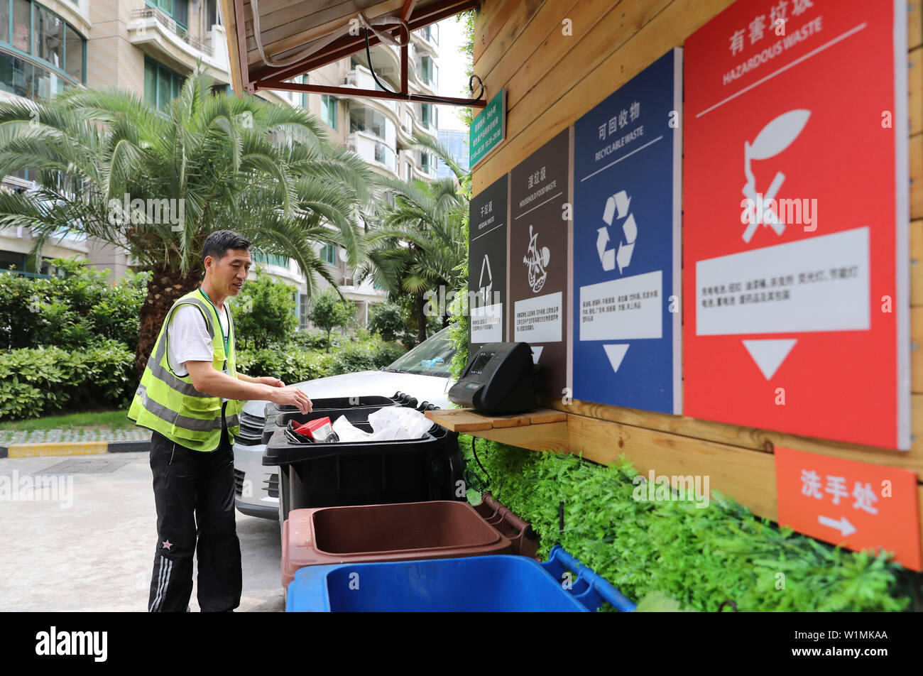Beijing, China. 24th June, 2019. A garbage sorting volunteer checks ...