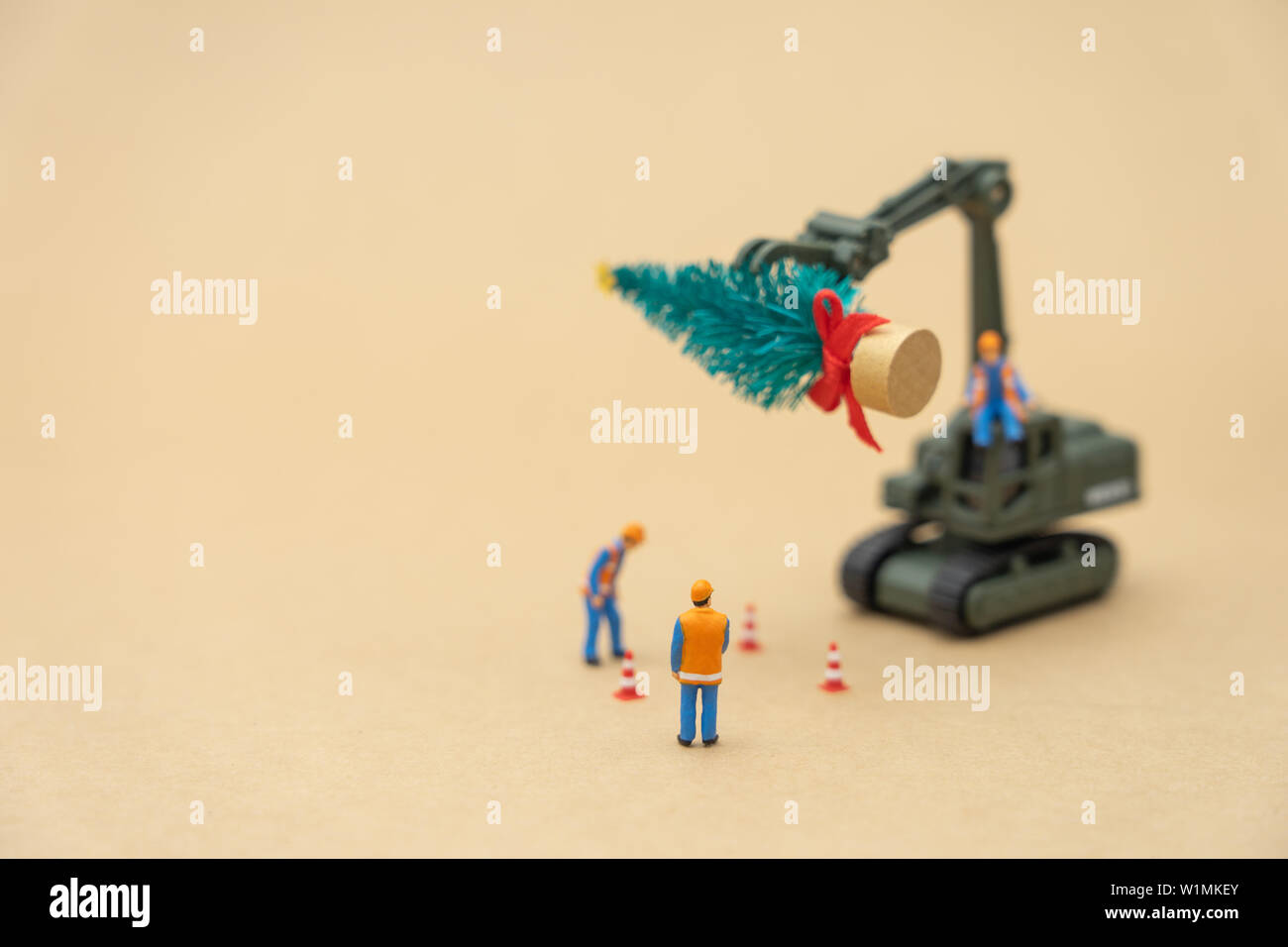 Miniature people Construction worker standing on Christmas tree ...
