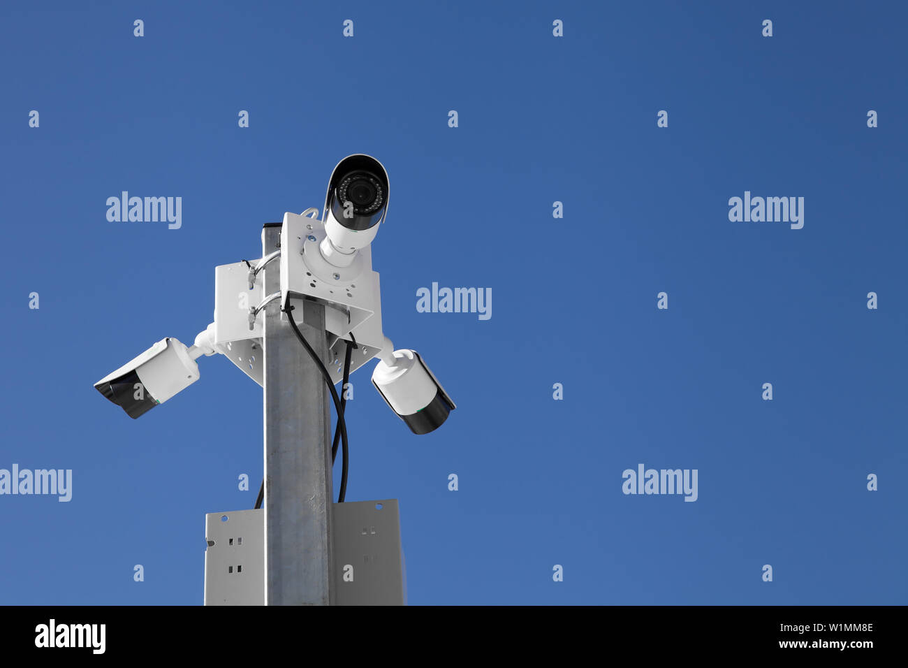 three surveillance cameras against the sky Stock Photo - Alamy