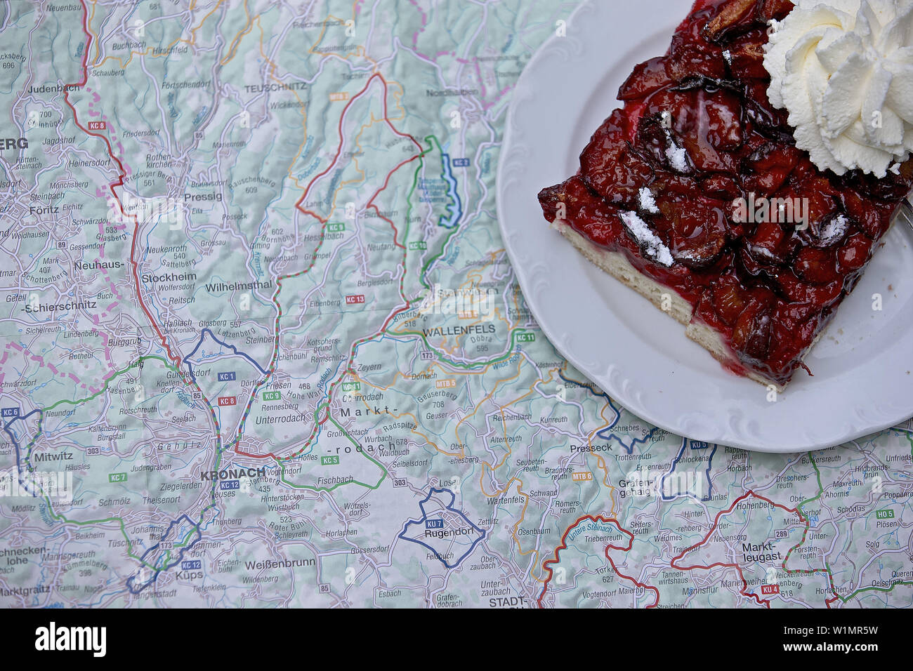 Delicious cake on a map Stock Photo - Alamy