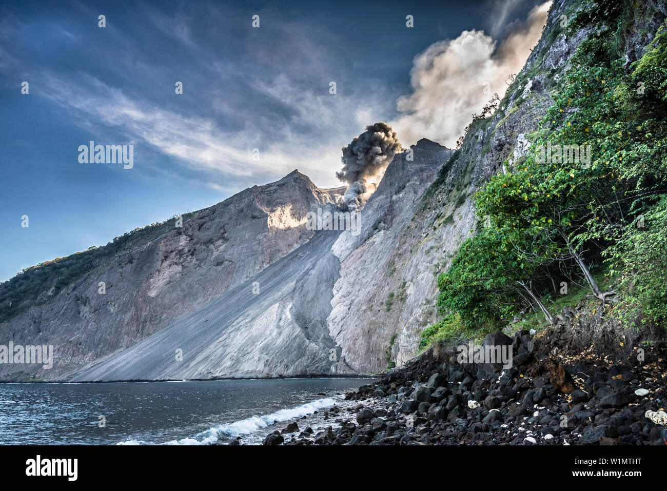 Large ash eruption with ejections of rocks at the burning edge of Batu ...