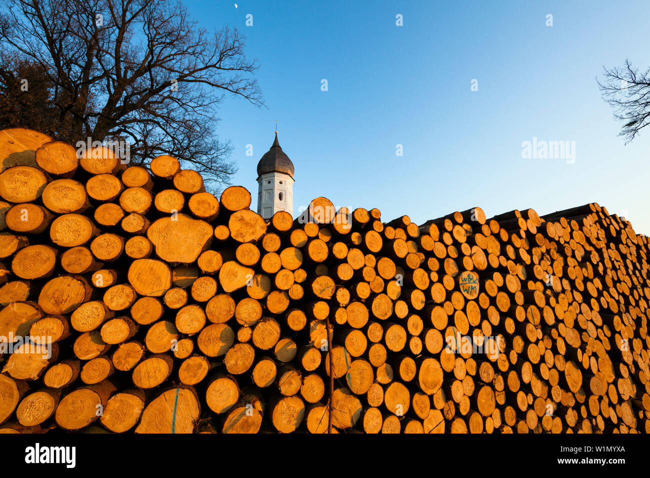 wood piling up in front of a church in Bavaria, Penzberg, Upper Bavaria ...