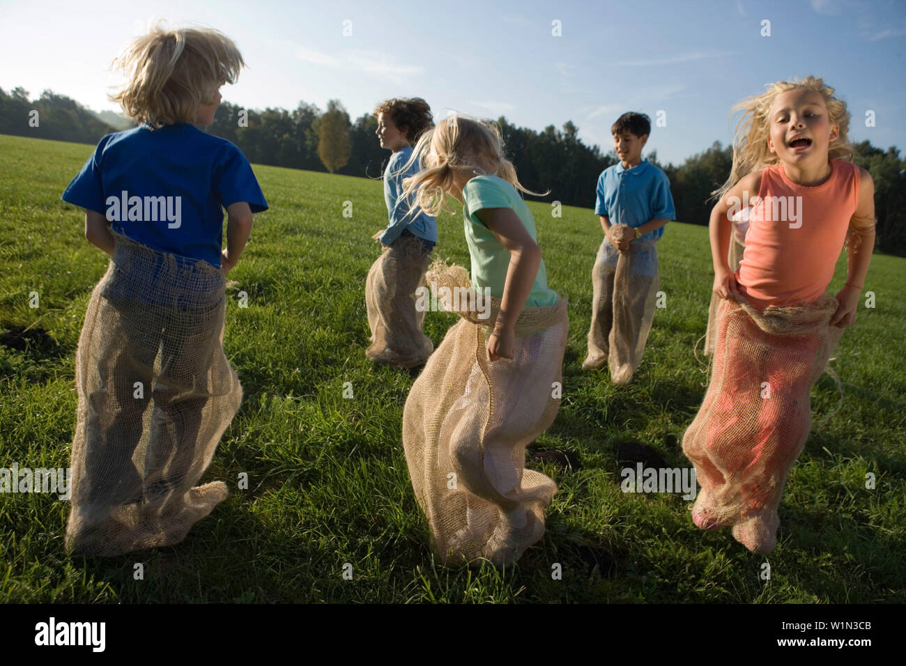 Group of children having a sack race, children's birthday party Stock ...