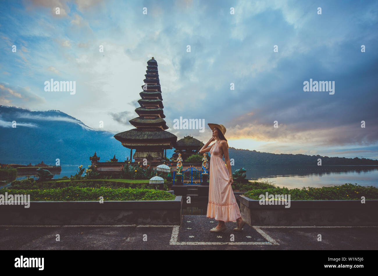 Beautiful girl visiting the ulun danu bratan temple in Bali. Concept ...