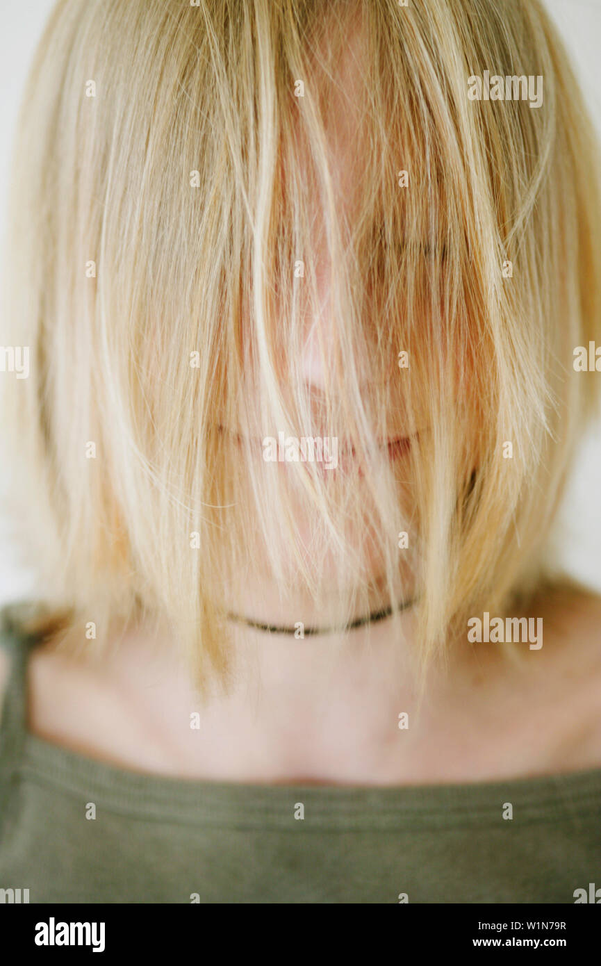 Girl (12 years) with hair covering face Stock Photo - Alamy