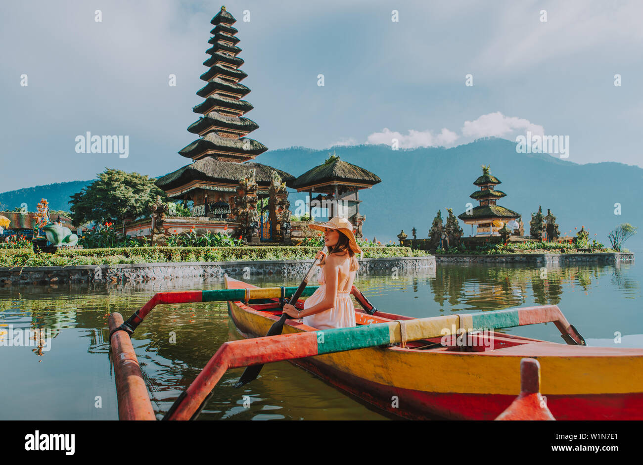 Beautiful girl kayaking on the catamaran at the ulun datu pura bratan ...