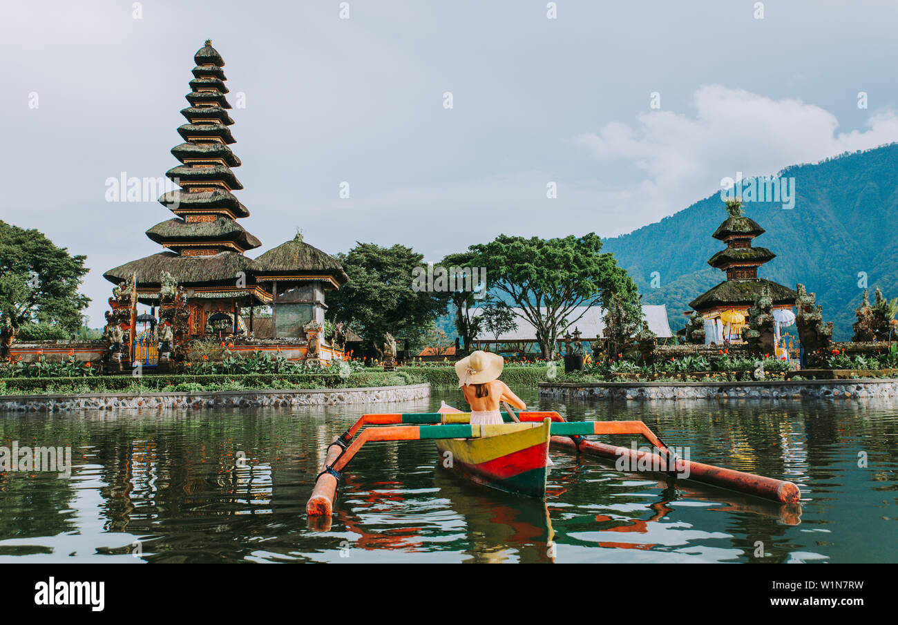 Beautiful girl kayaking on the catamaran at the ulun datu pura bratan ...