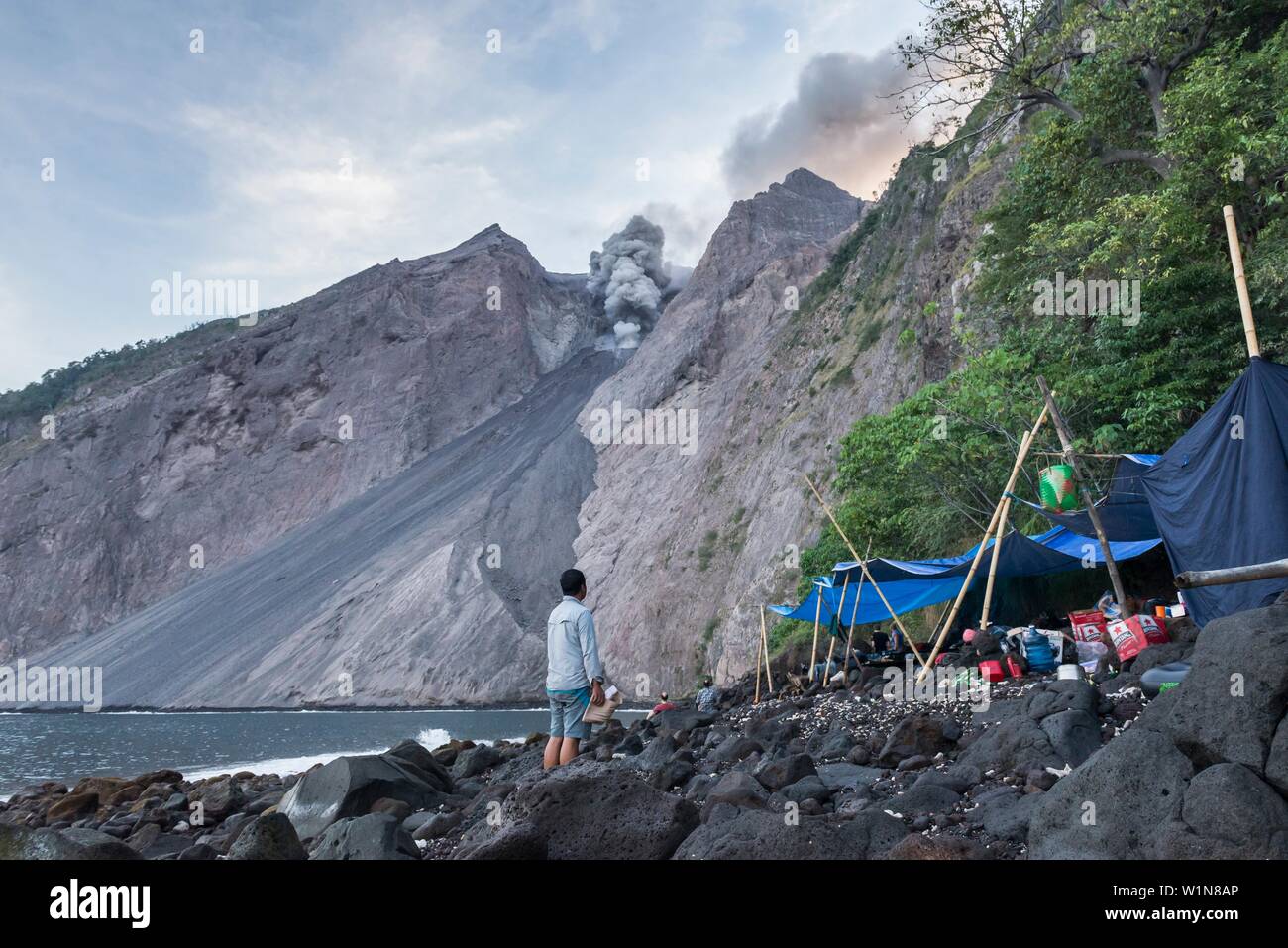 Base Camp at the foot of the active volcano Batu Tara between the sea ...